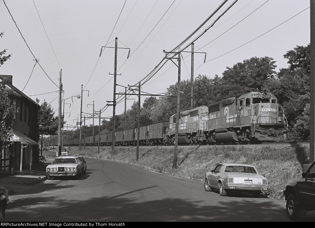 CR 3295 leads a string of empty hoppers north past Front Street